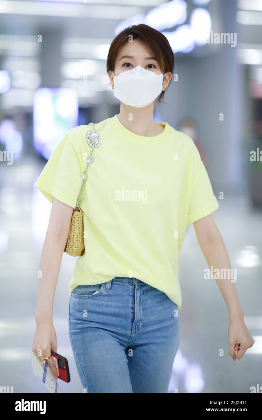 Chinese actress Qiao Xin arrives at a Shanghai airport before departure ...