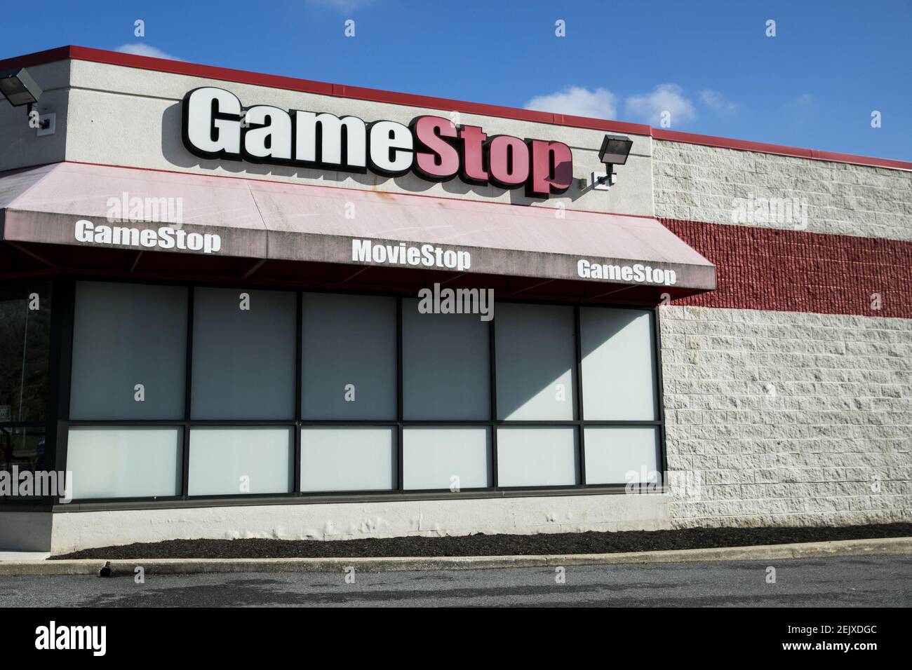 A logo sign outside of a GameStop retail store location in Towson ...
