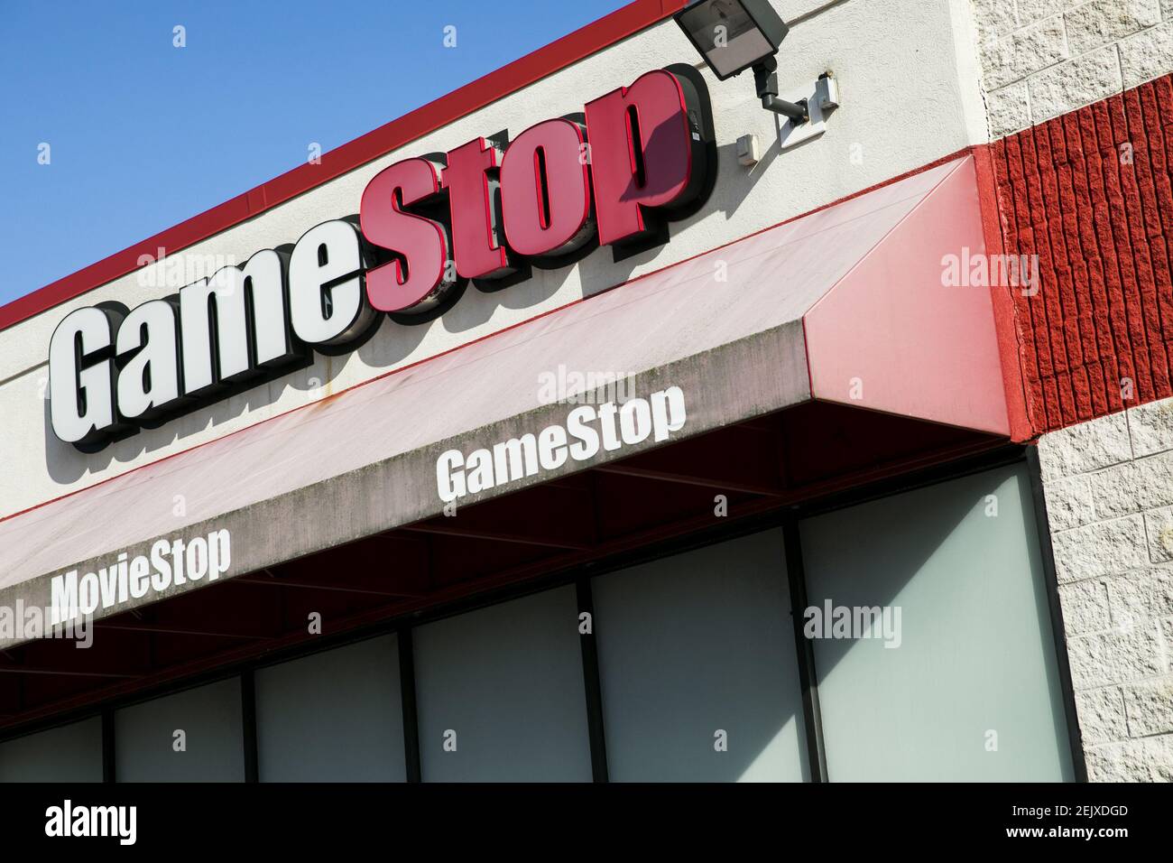 A logo sign outside of a GameStop retail store location in Towson ...