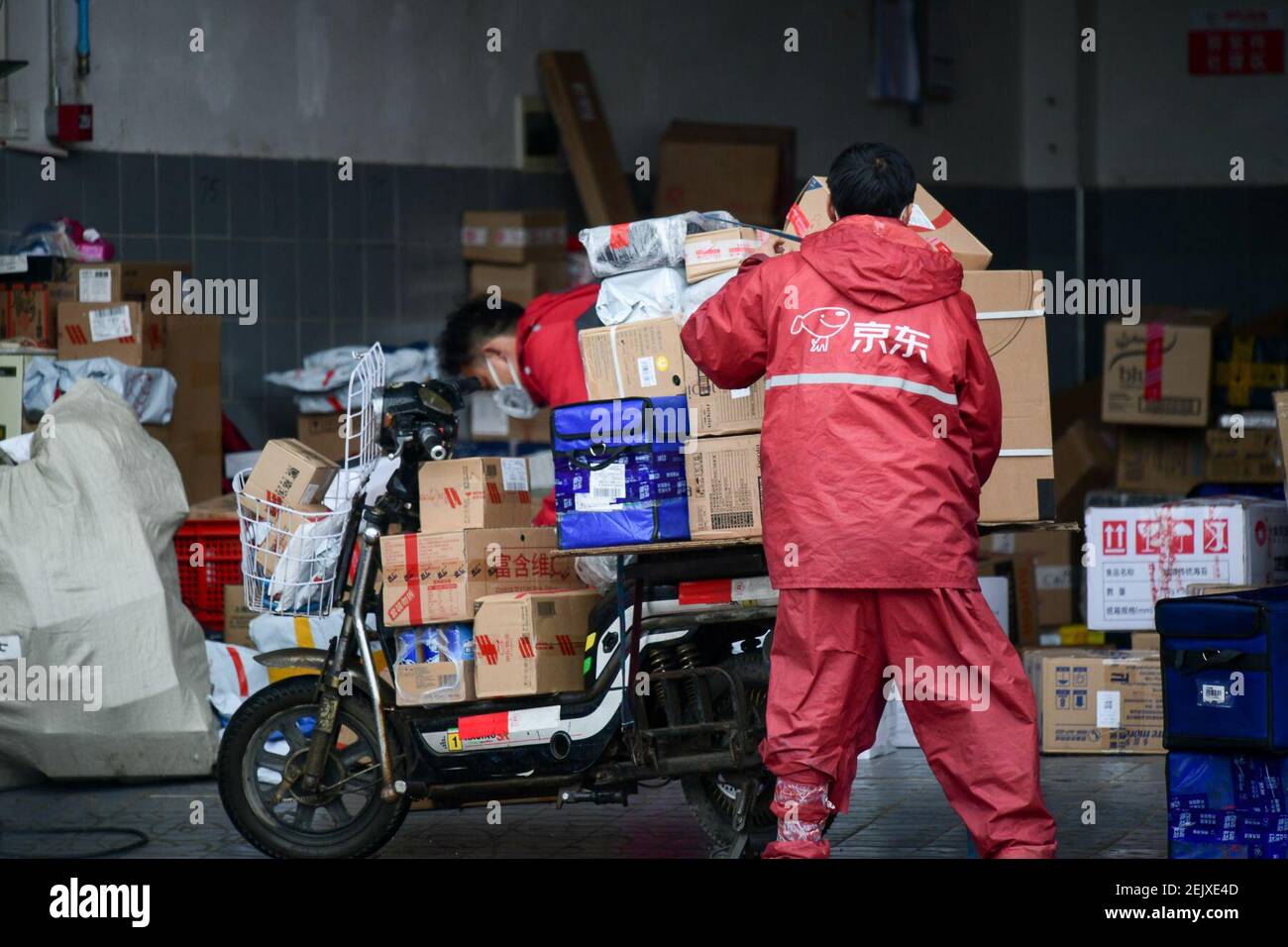 A delivery guy of JD.com uploads deliveries in Wuhan city, south China ...