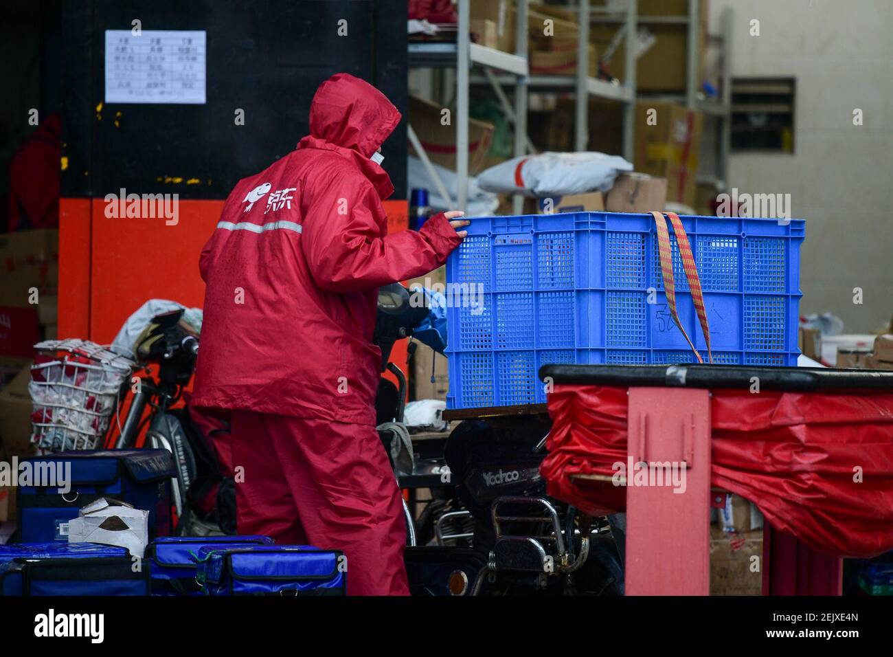 A delivery guy of JD.com uploads deliveries in Wuhan city, south China ...