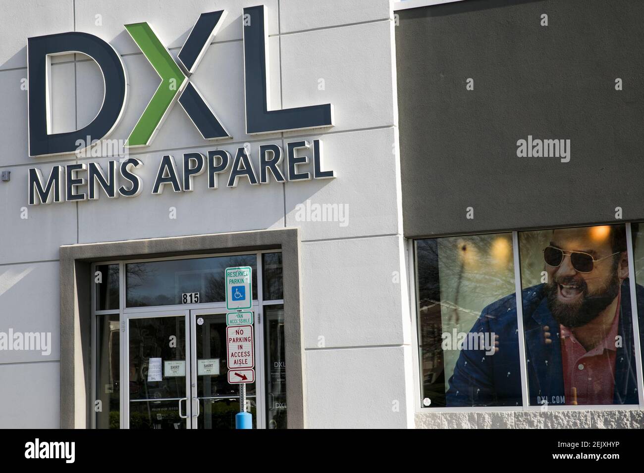 A logo sign outside of a Destination XL (DXL) retail store location in ...