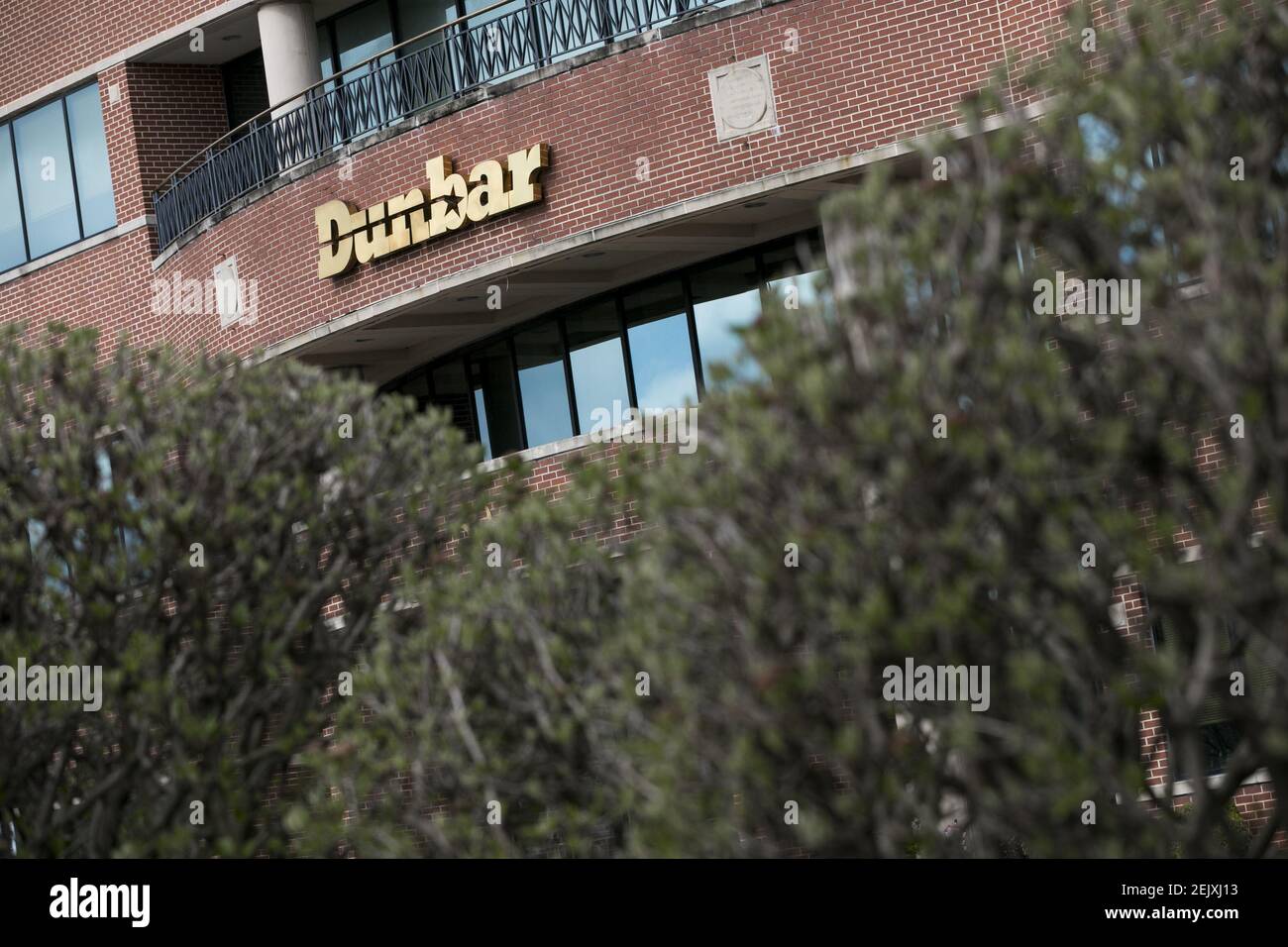 A logo sign outside of the headquarters of Dunbar Armored in Hunt ...