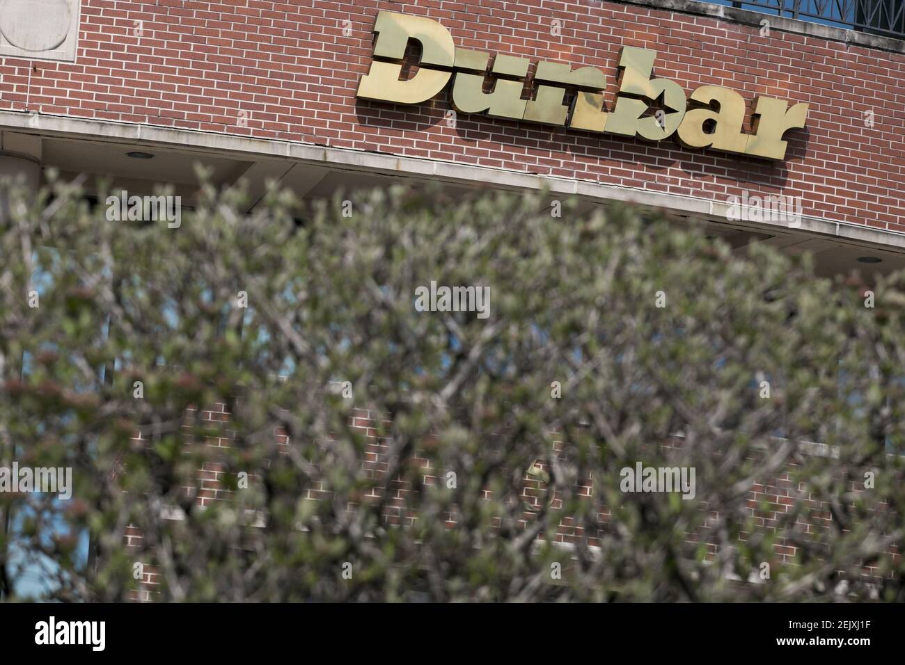 A logo sign outside of the headquarters of Dunbar Armored in Hunt ...
