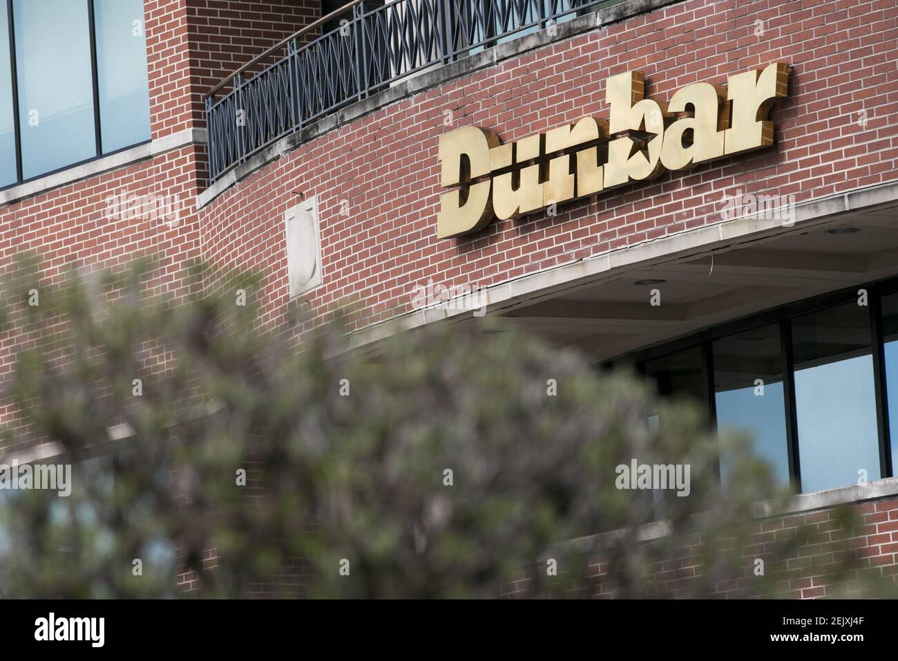 A logo sign outside of the headquarters of Dunbar Armored in Hunt ...