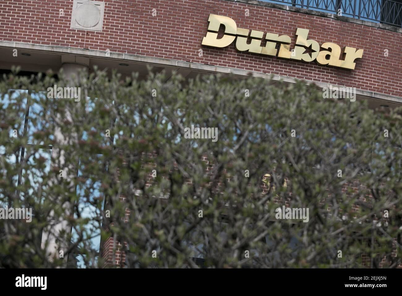 A logo sign outside of the headquarters of Dunbar Armored in Hunt ...