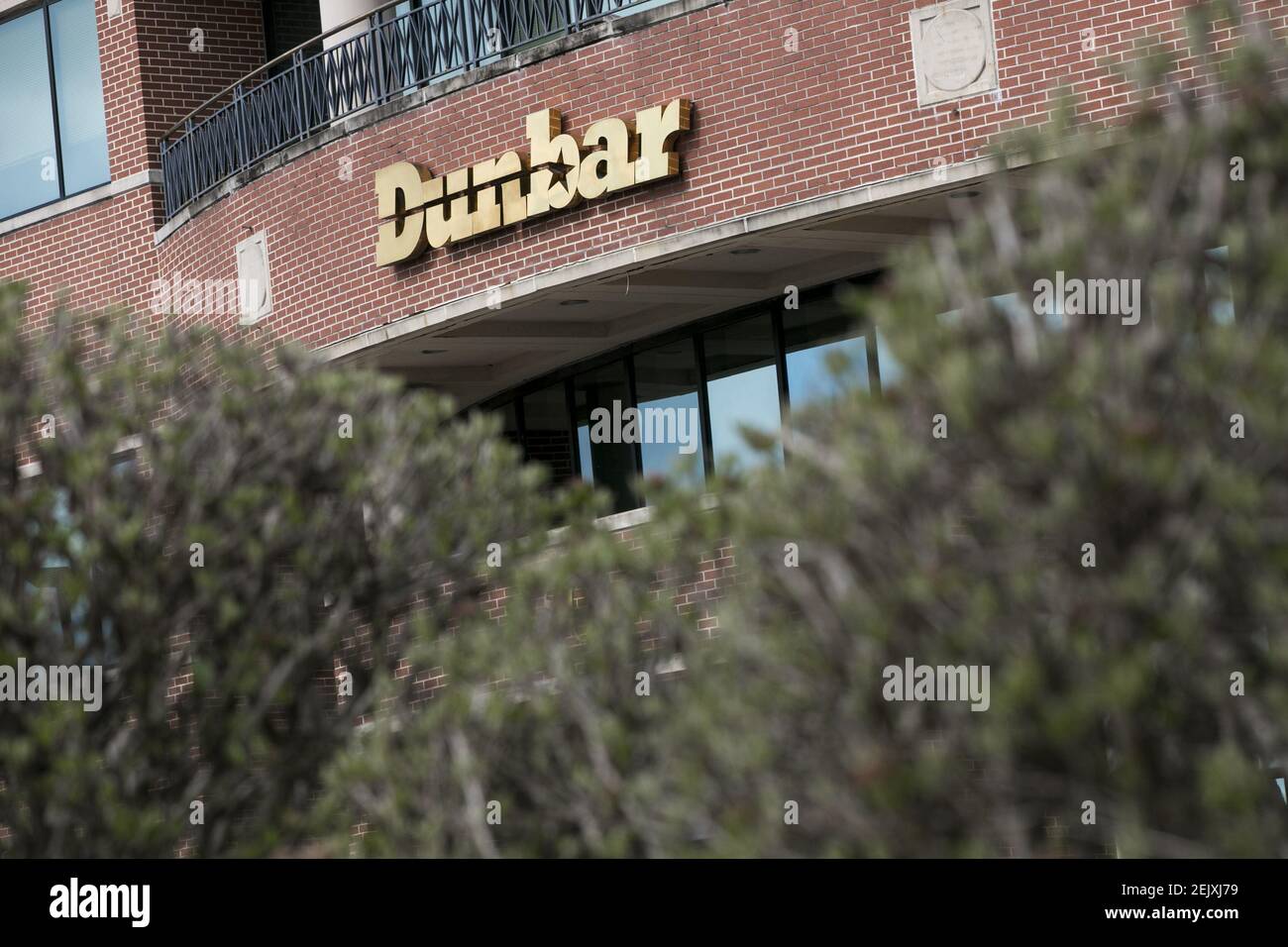 A logo sign outside of the headquarters of Dunbar Armored in Hunt ...