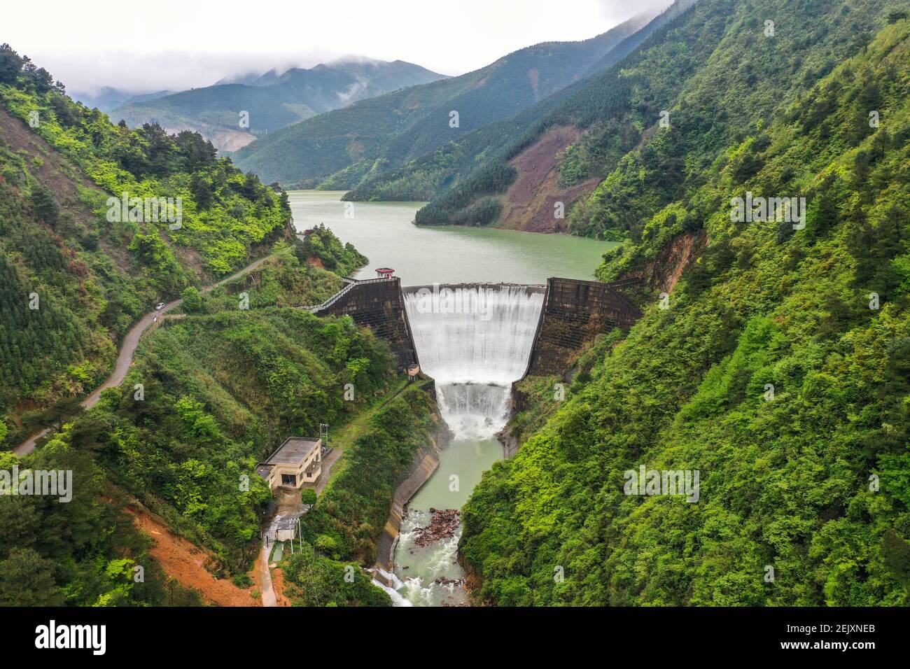 Torrential rain caused the reservoir to overflow into a waterfall ...