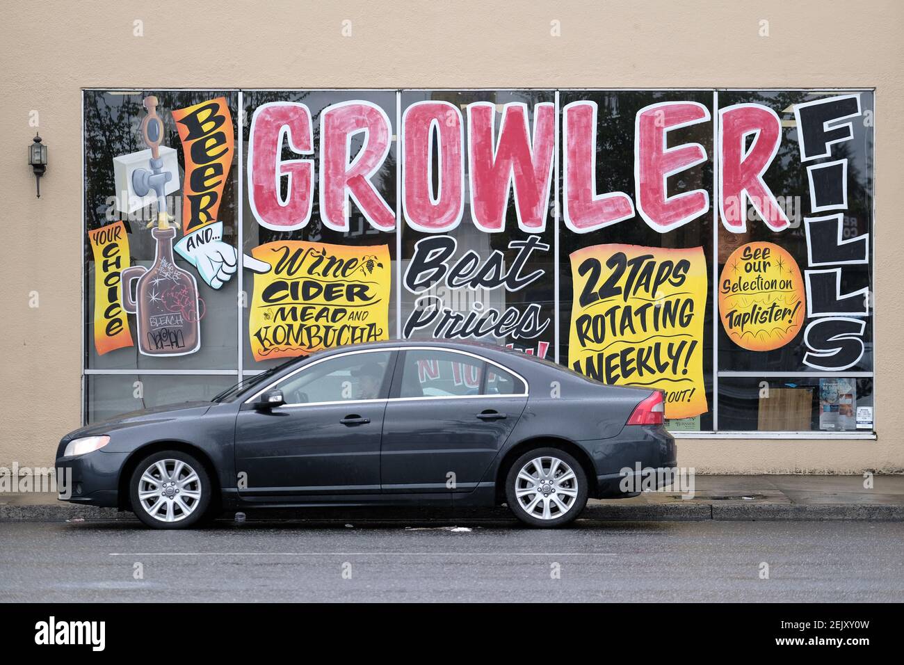 A man waits in his car outside Hollywood Beverage, which has seen an ...