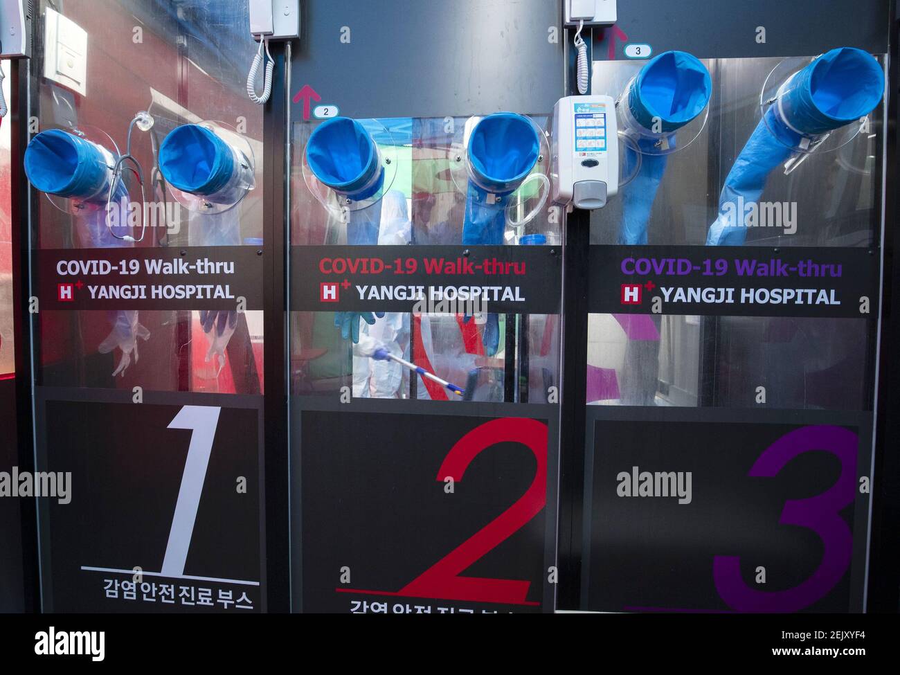 South Korean member of medical team disinfects a booth of single-person ...