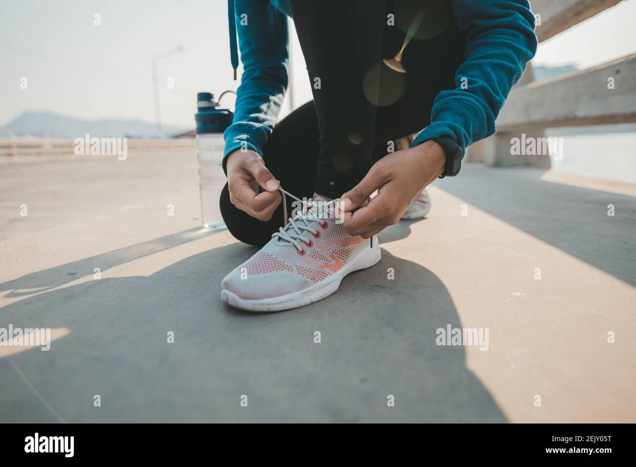 Woman tying shoe laces. Woman fitness runner get ready for jogging on ...