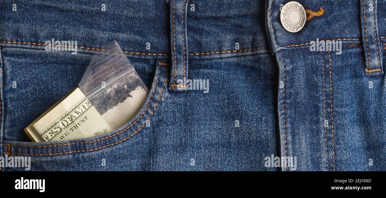 crumpled dollars and a drug bag in jeans pocket. Close up, no face ...