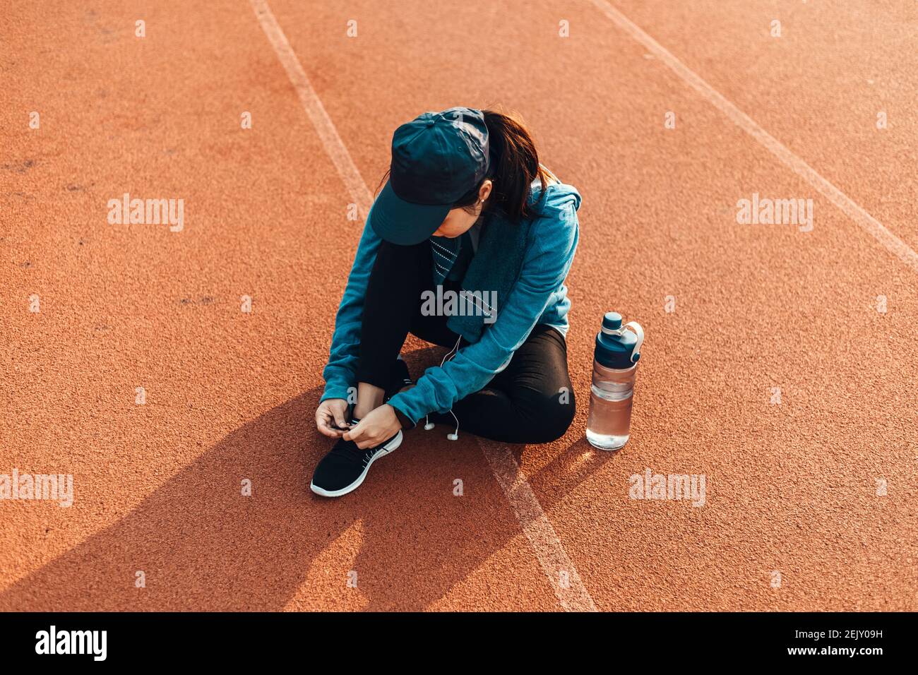 Woman tying shoe laces. Woman fitness runner get ready for jogging on ...