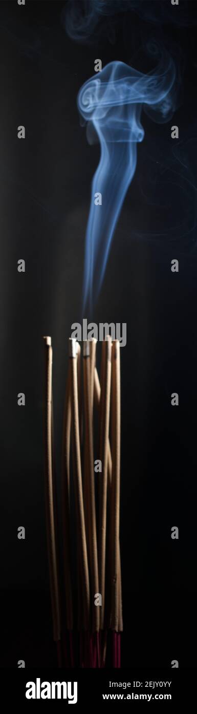 Incense burning incense, white smoke, black background, used as ...