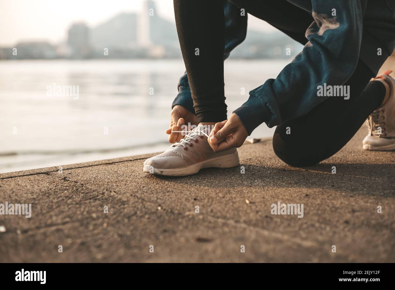 Woman tying shoe laces. Woman fitness runner get ready for jogging on ...