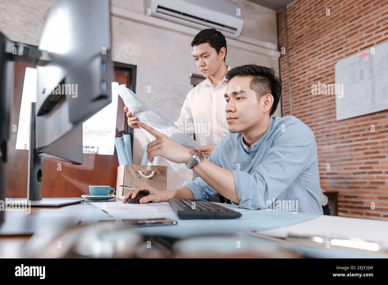 engineers reading building and drawing outlay construction plan as ...