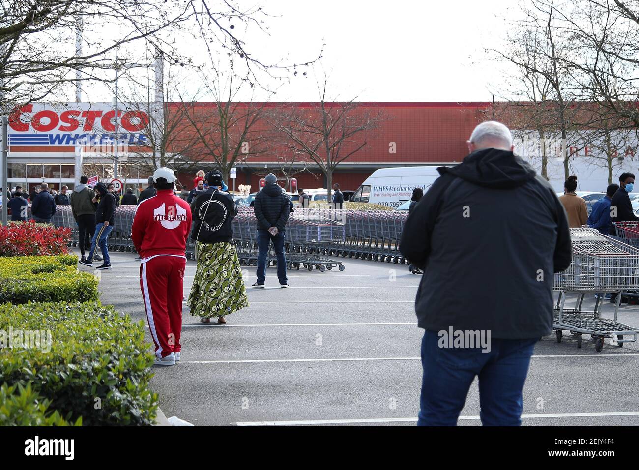 Shoppers queue for supplies at a Costco Wholesale Cash and Carry store ...