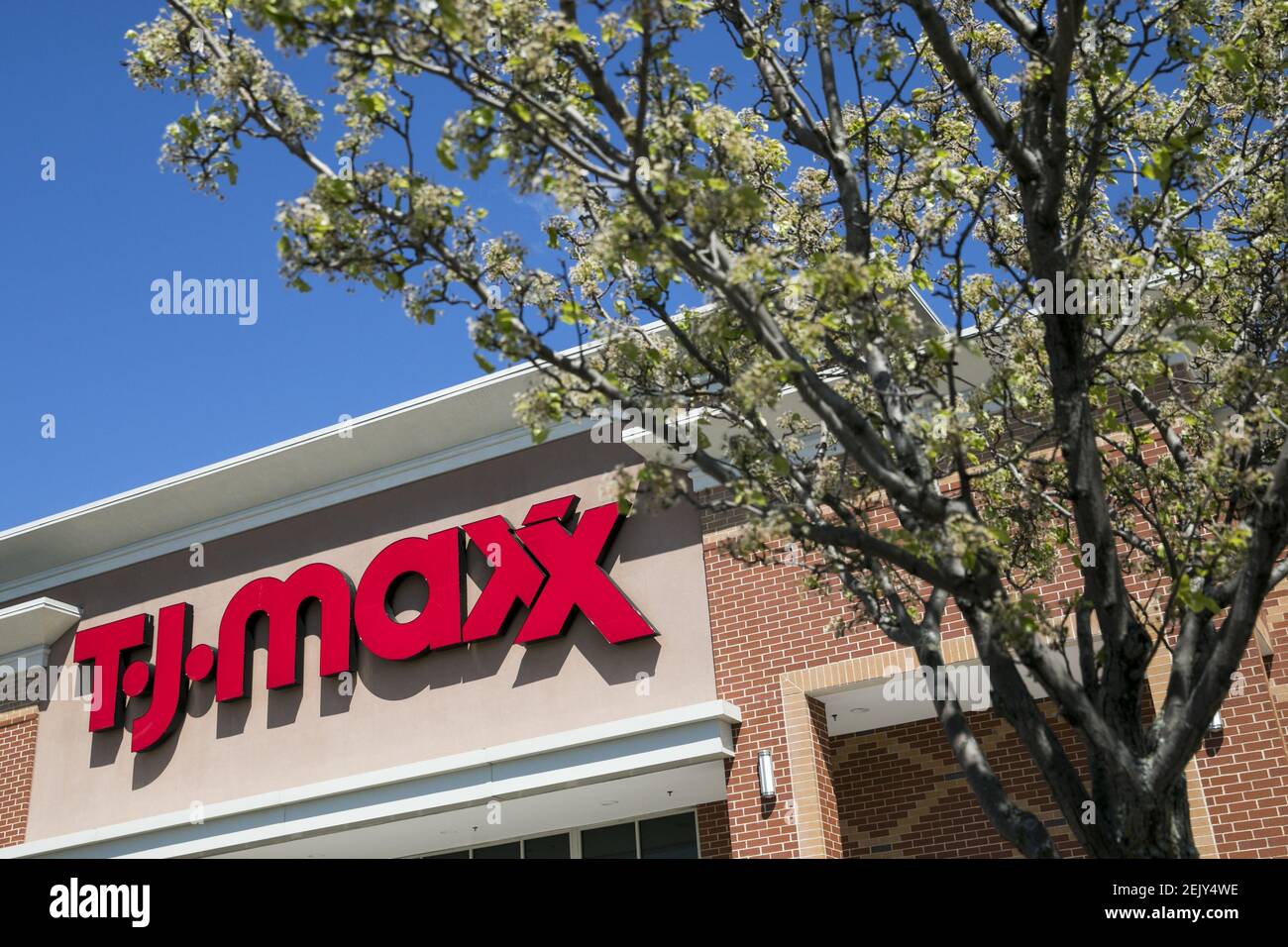 A logo sign outside of a TJ Maxx retail store location in Stafford ...