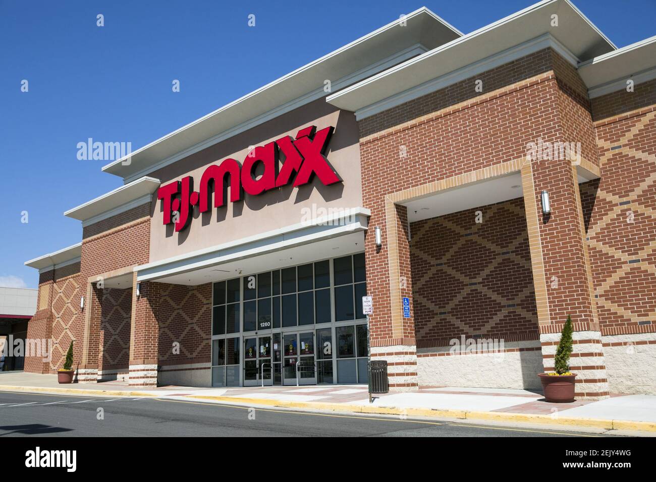 A logo sign outside of a TJ Maxx retail store location in Stafford ...