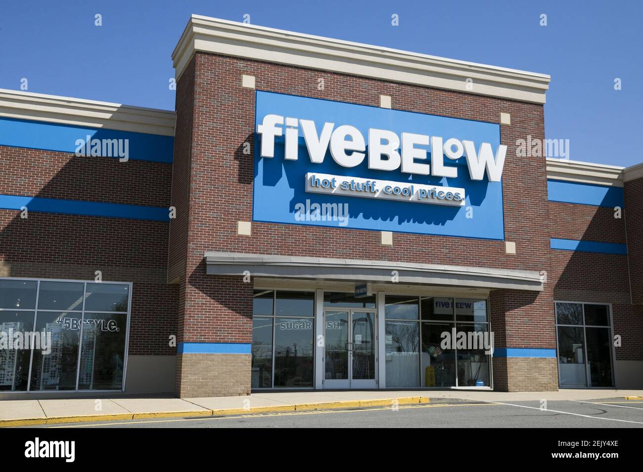 A logo sign outside of a Five Below retail store location in ...