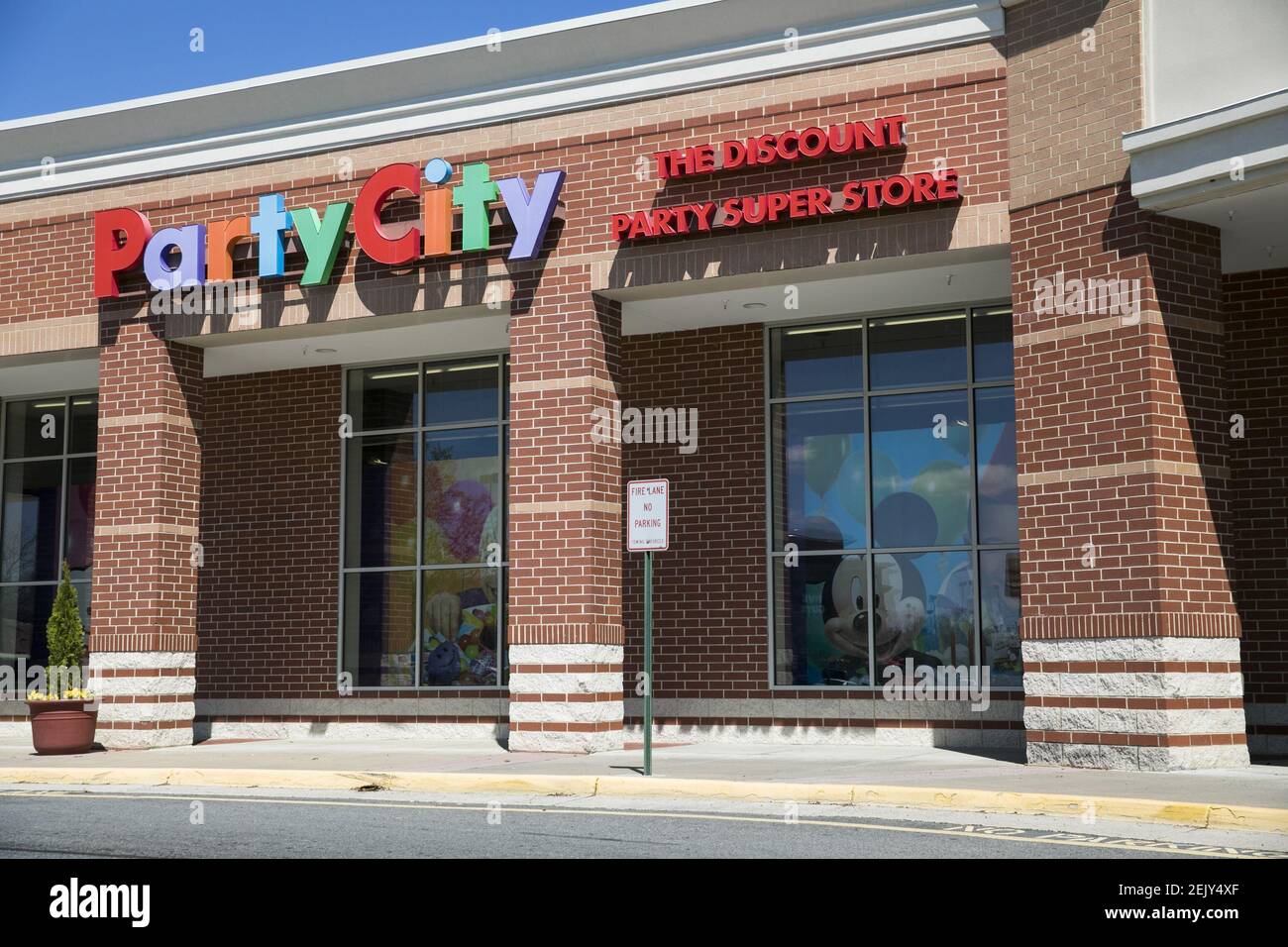 A logo sign outside of a Party City retail store location in Stafford ...