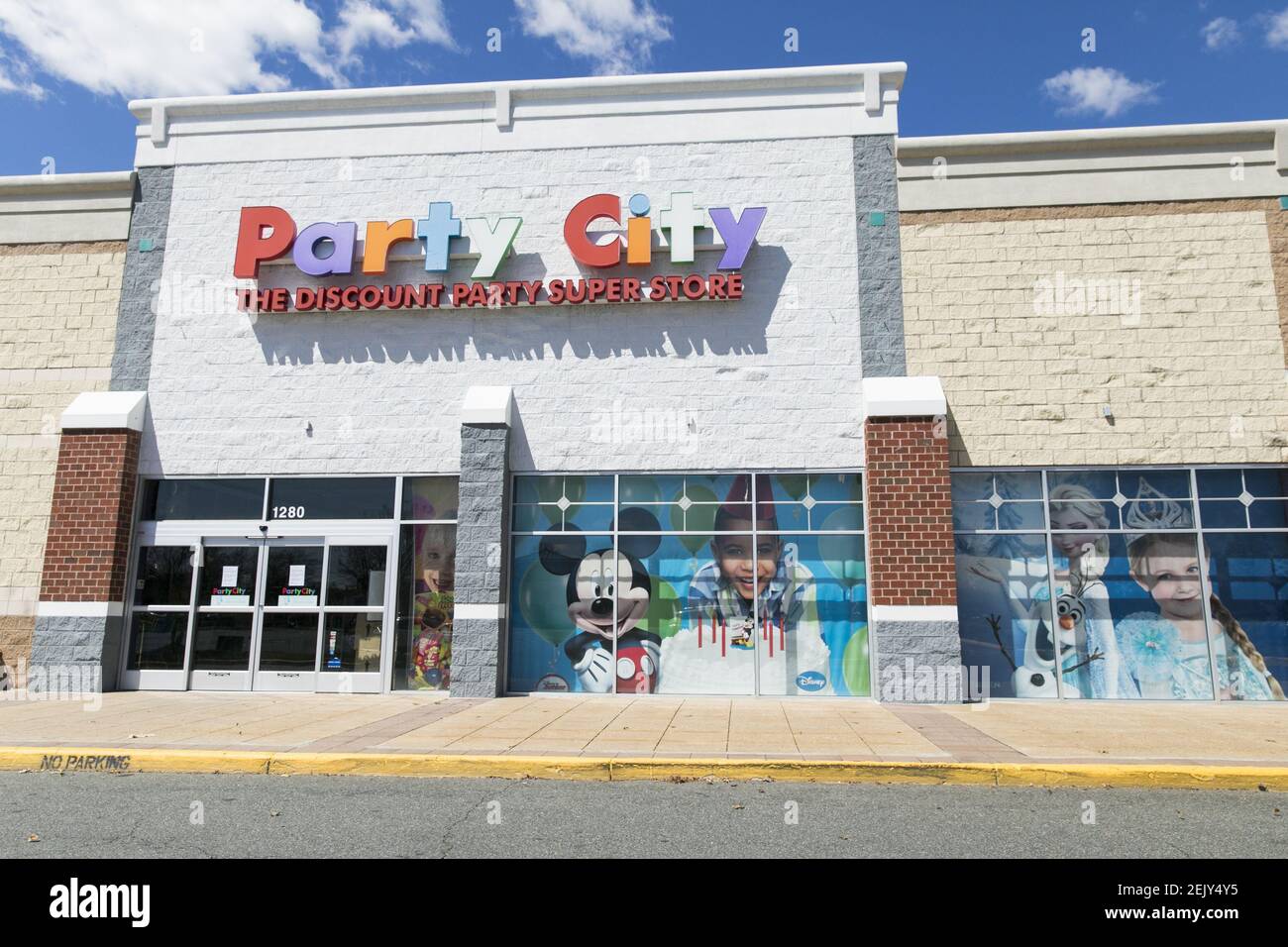 A logo sign outside of a Party City retail store location in ...