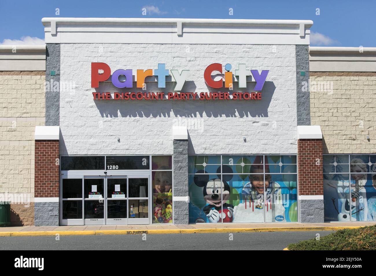 A logo sign outside of a Party City retail store location in ...