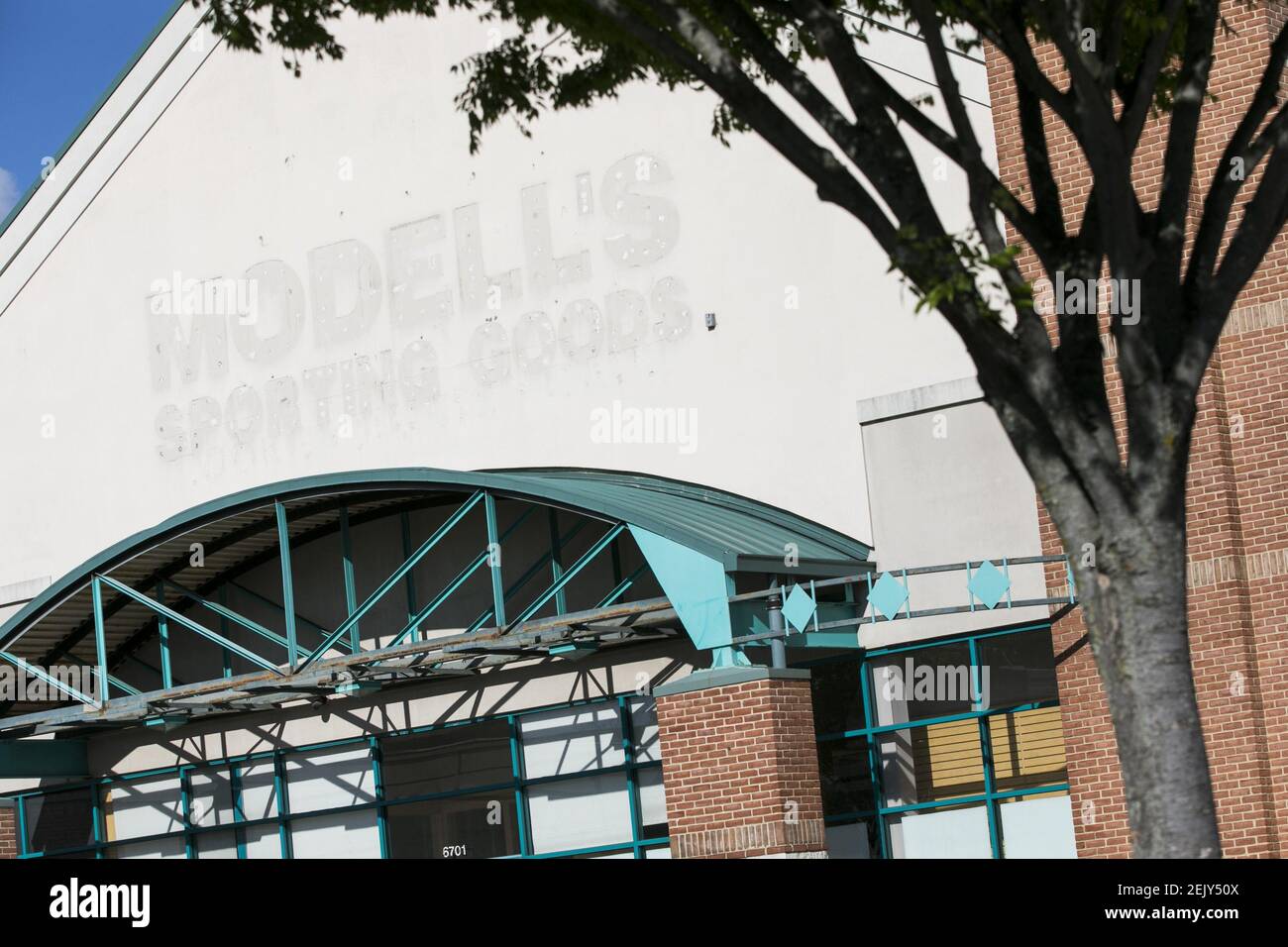 The faded outline of a logo sign outside of a closed and abandoned ...