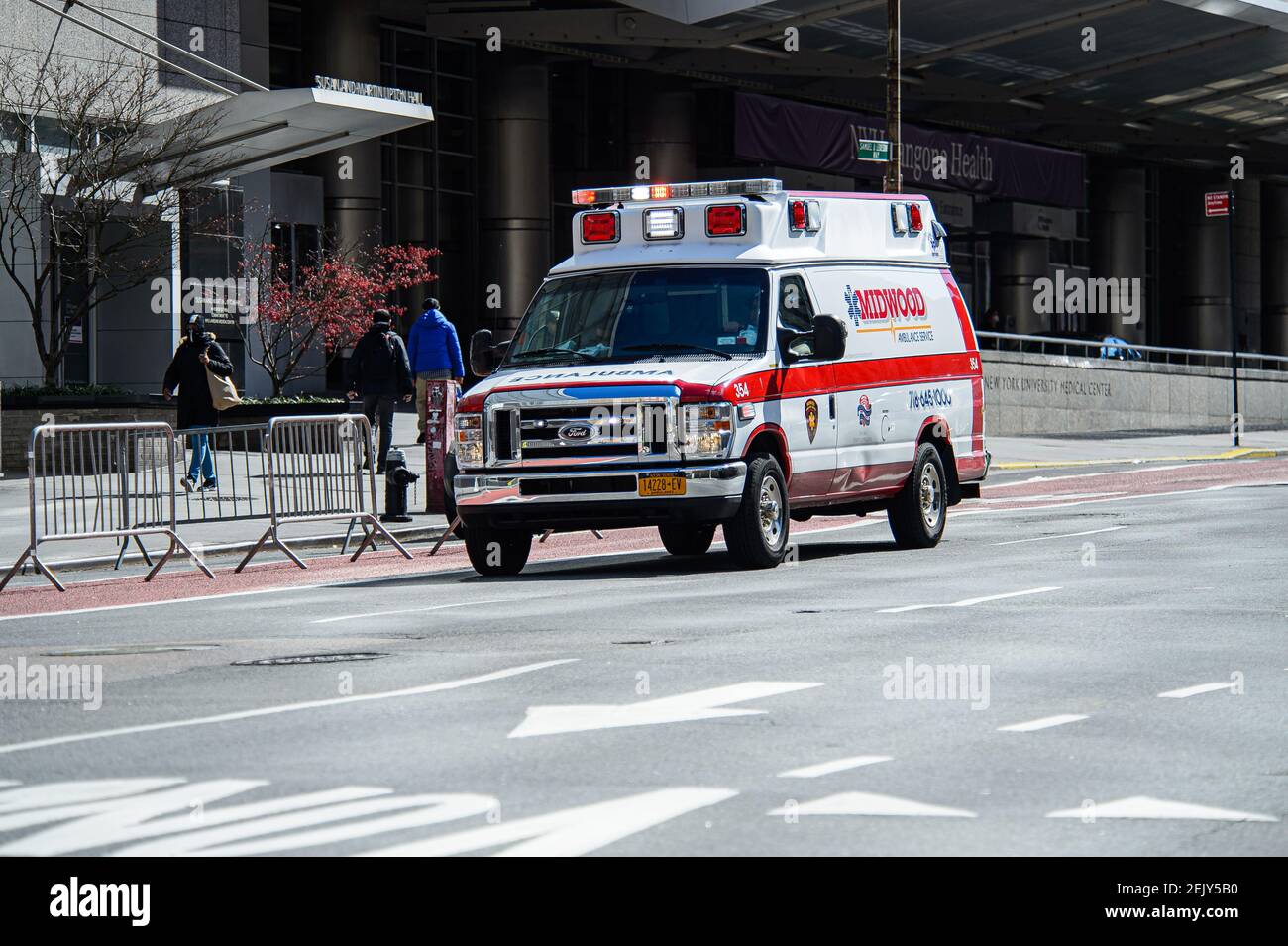 An ambulance with its emergency lights on is seen racing on First ...