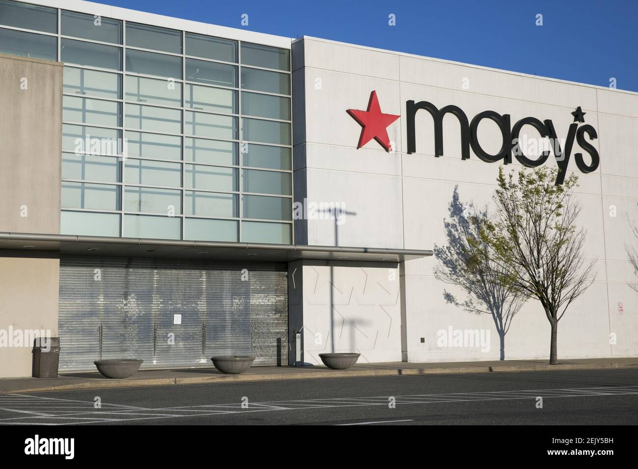 A logo sign outside of a Macy's retail store location in Wheaton ...