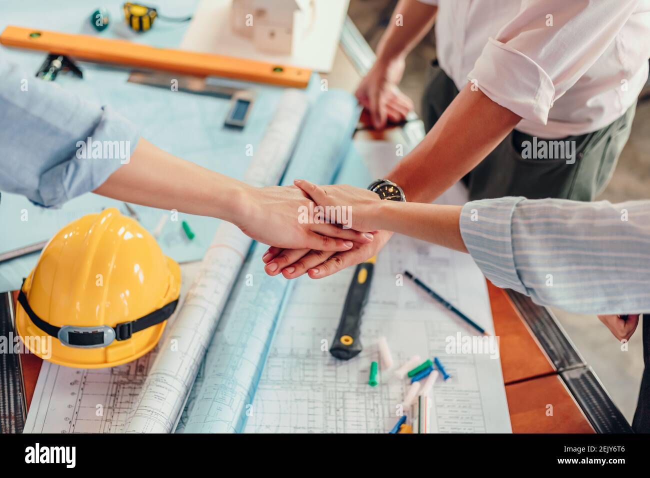 Engineer and architect partners team work join hands together. group ...