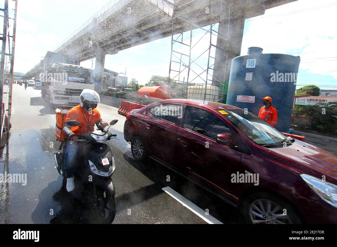 Vehicles passing on the “Disinfecting Station” to sanitize each ...