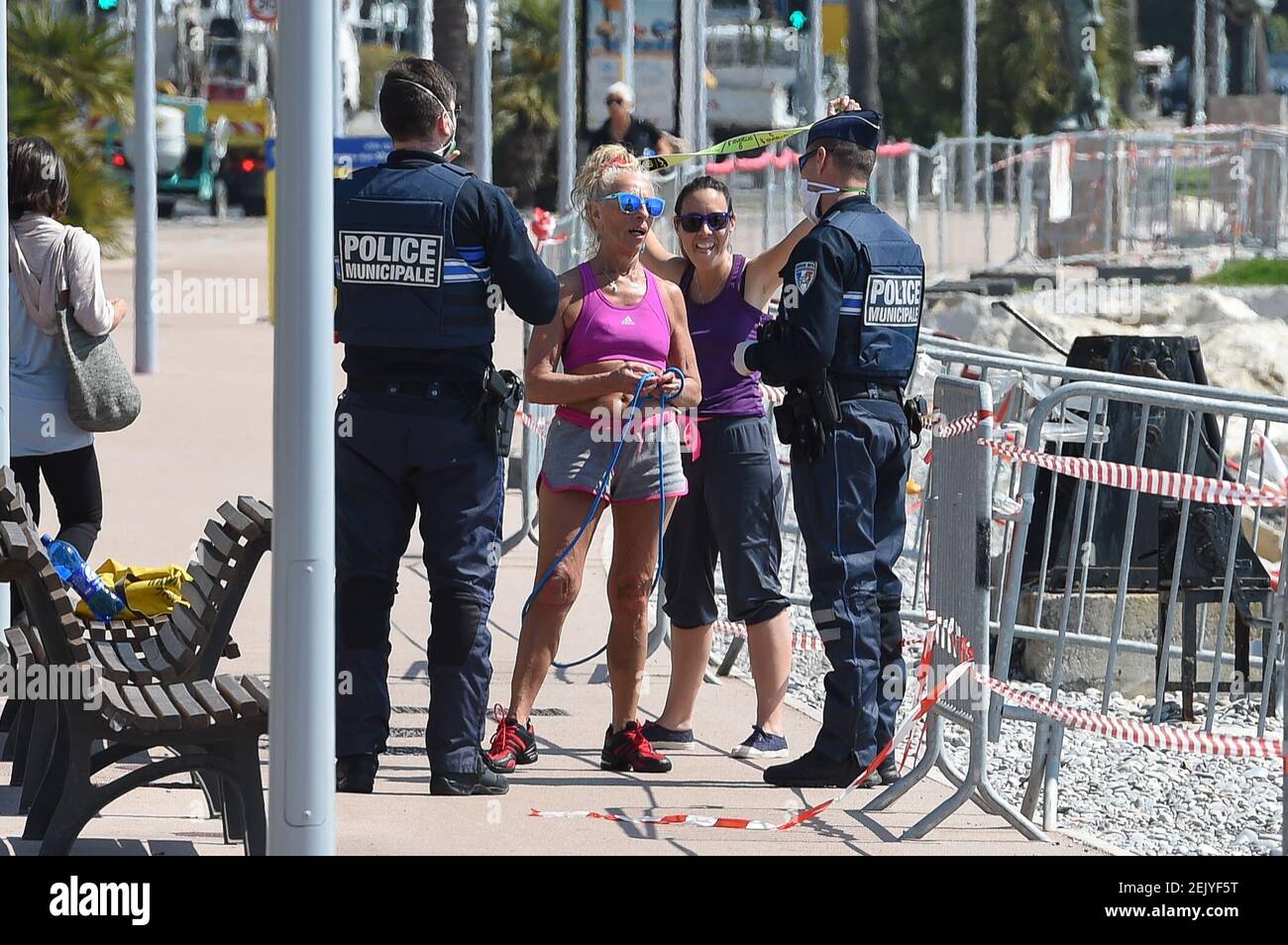 People speak with police officers outside during the Covid-19 ...