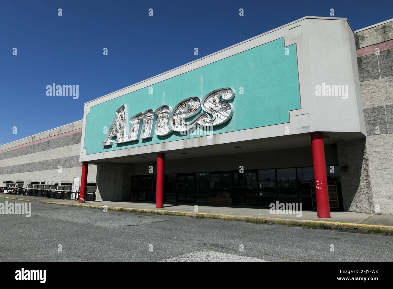 A logo sign outside of a closed and abandoned Ames Department Stores ...