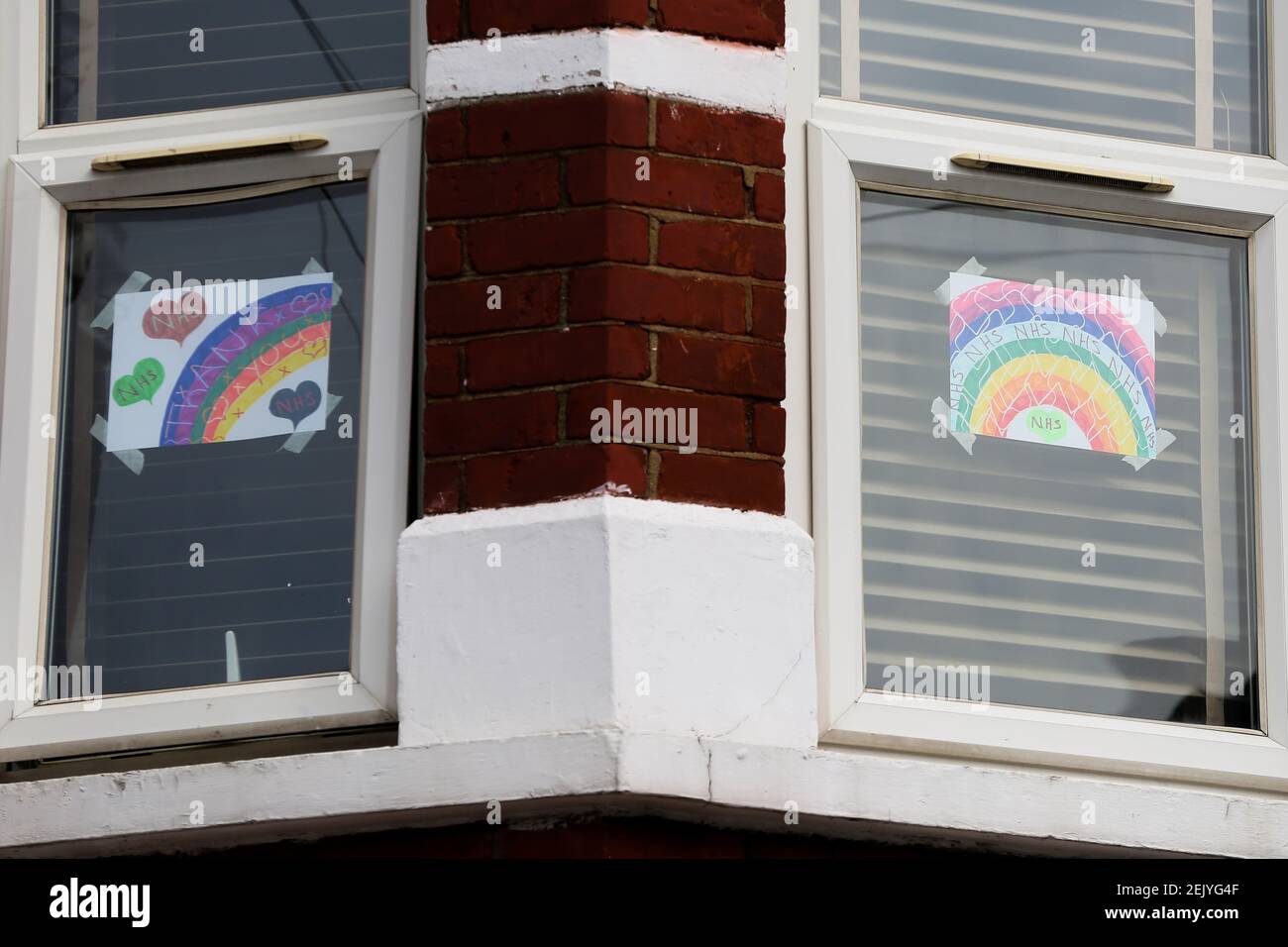 Hand painted pictures of colourful rainbows are displayed in windows of a home in north London ...