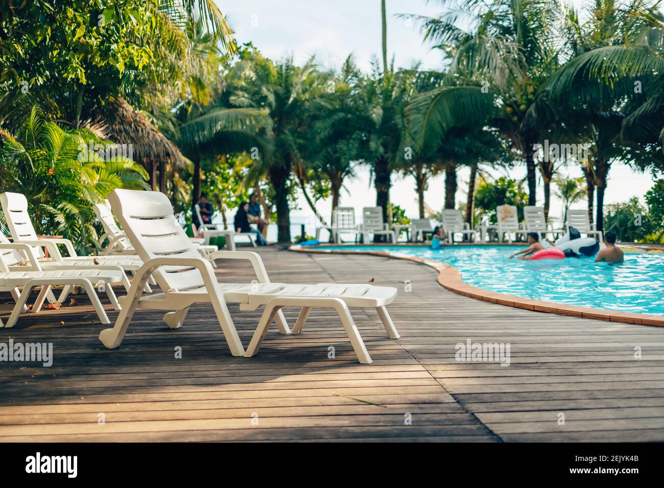 Lounge chairs near the pool at the hotel Stock Photo - Alamy
