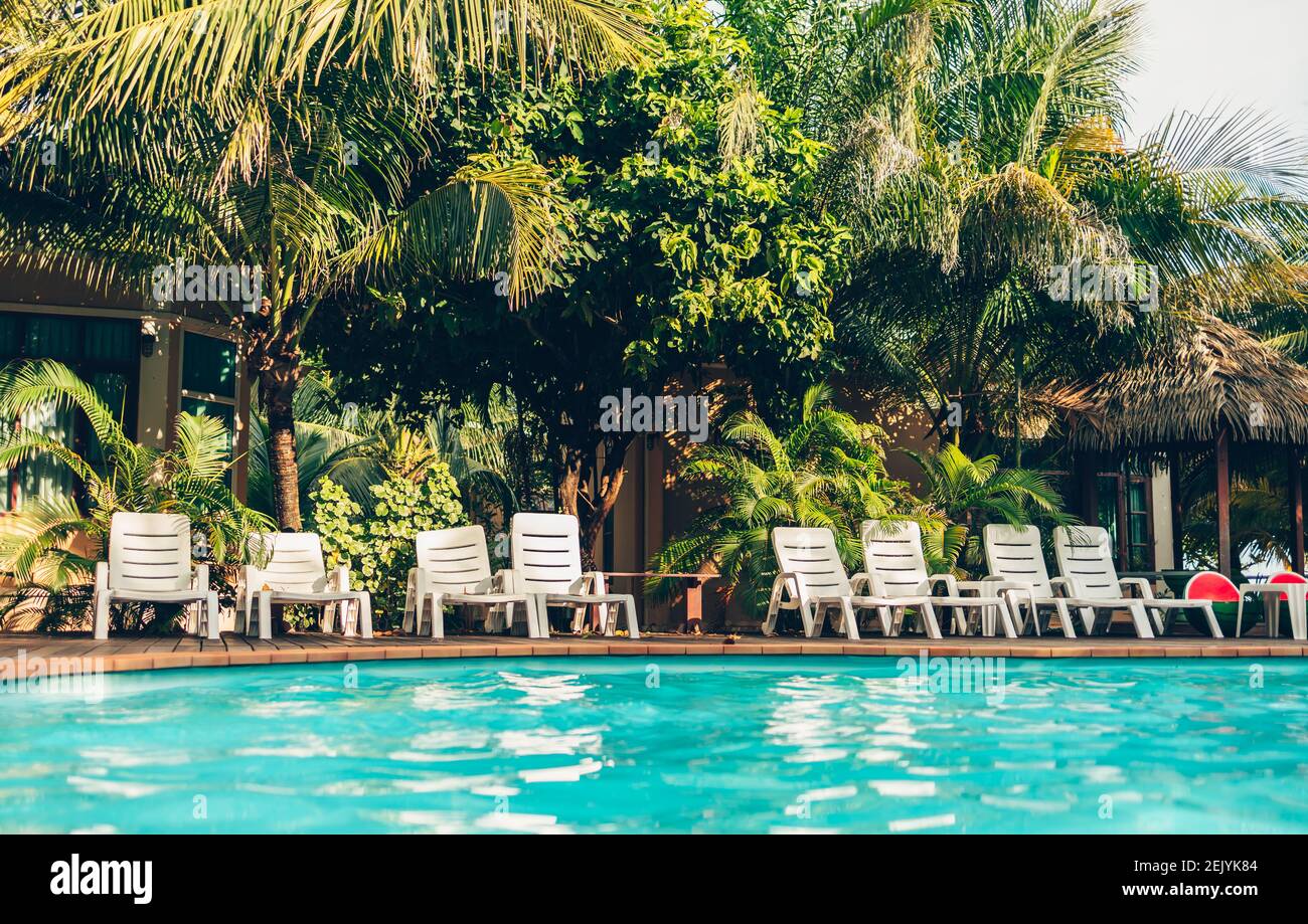 Lounge chairs near the pool at the hotel Stock Photo - Alamy