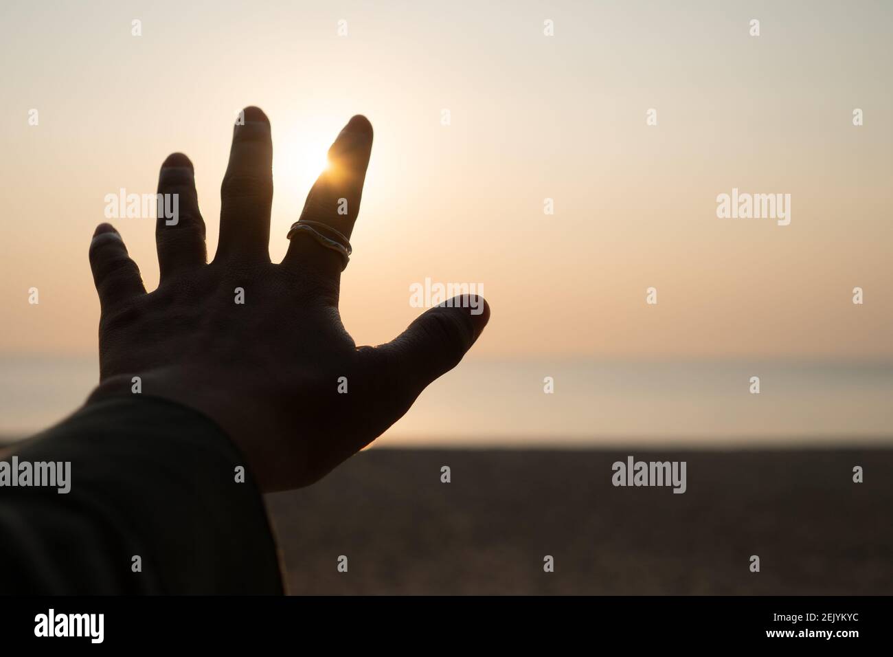 Hand reach out to sunset sky beach sand nature background. Relax and ...
