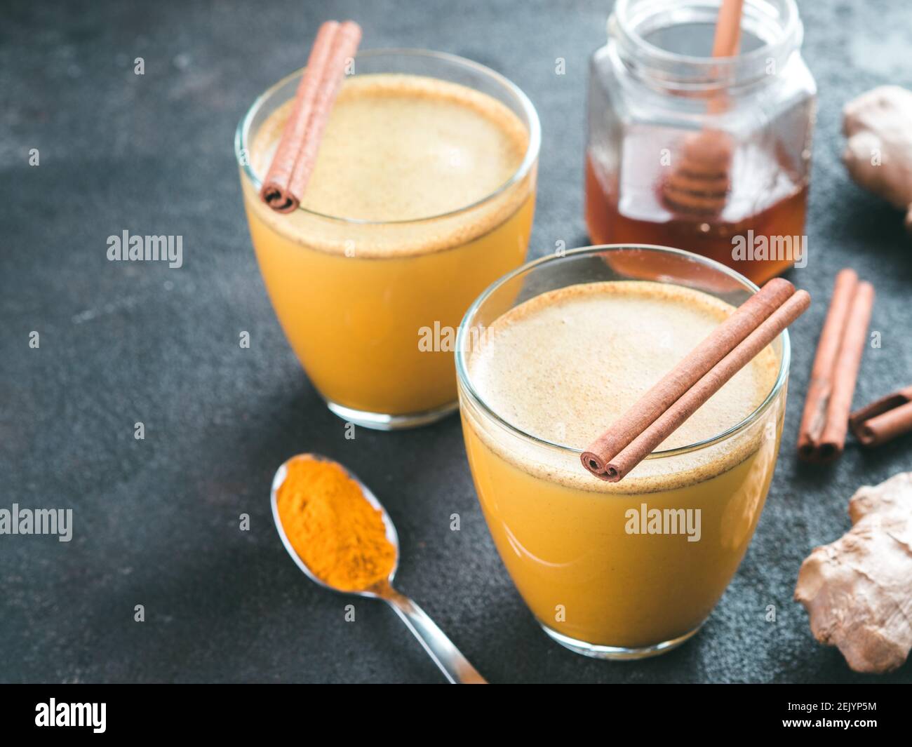 Healthy drink golden turmeric latte in glass.Gold milk with turmeric ...