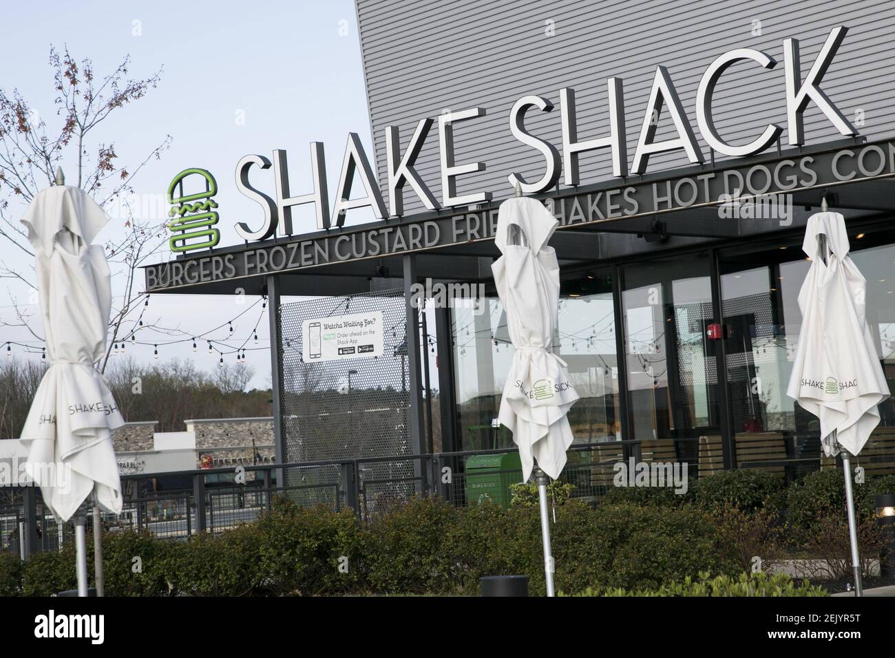A logo sign outside of a Shake Shack restaurant location in Newark ...