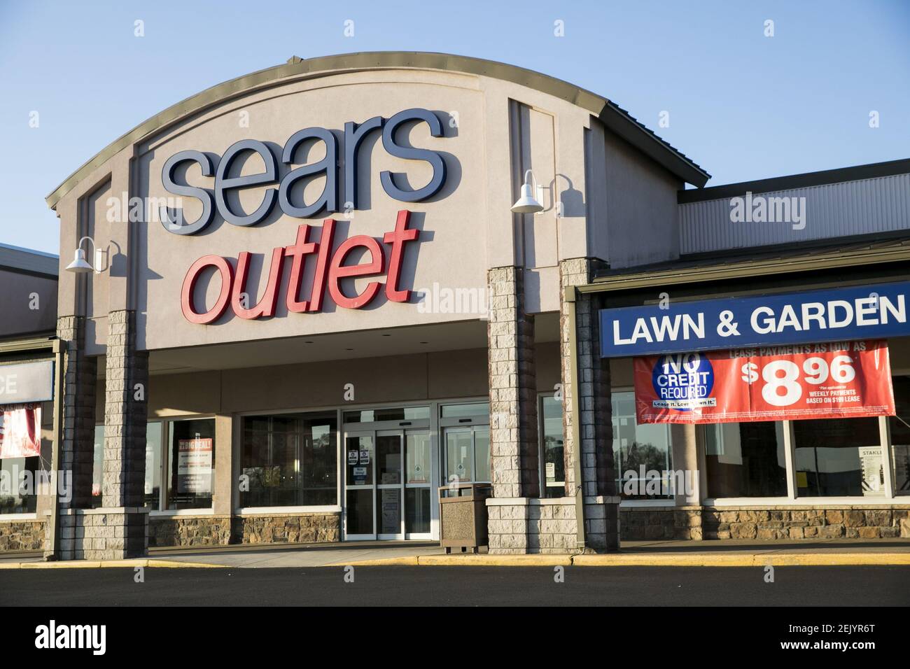 A logo sign outside of a Sears Outlet retail store location in Newark ...