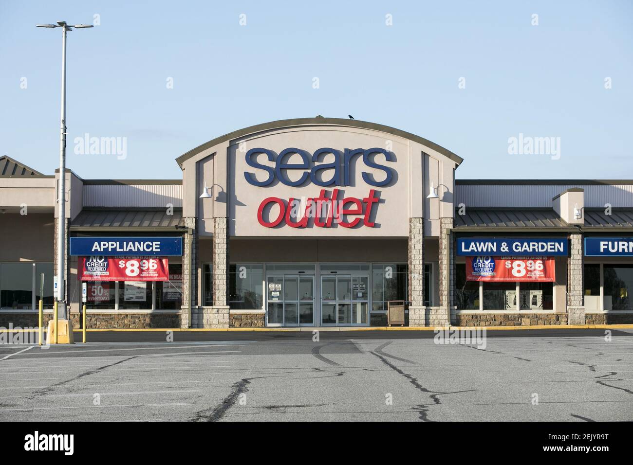 A logo sign outside of a Sears Outlet retail store location in Newark ...