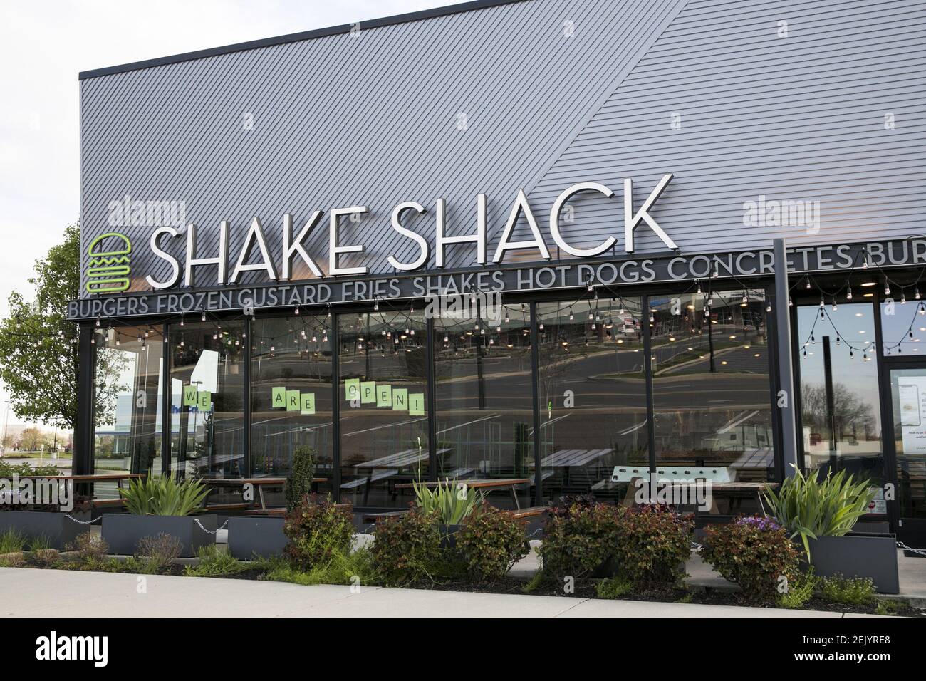 A logo sign outside of a Shake Shack restaurant location in Newark ...