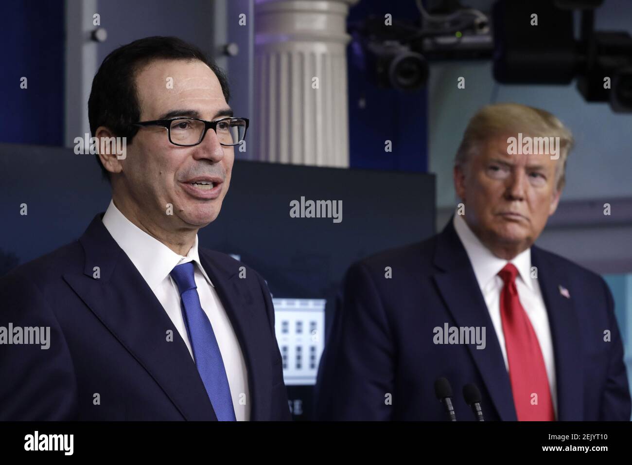 U.S. Treasury Secretary Steve Mnuchin speaks next to President Donald ...