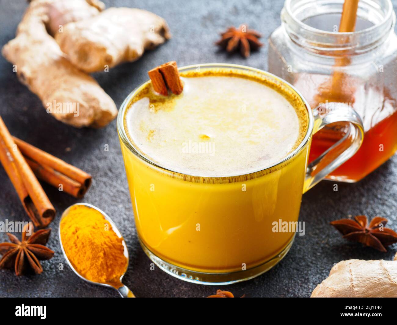 Healthy drink golden turmeric latte in glass cup.Gold milk with ...