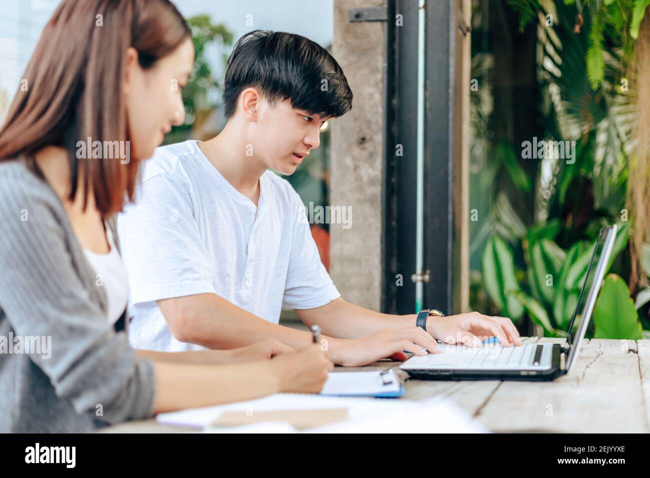 High school or college students group catching up workbook and learning ...