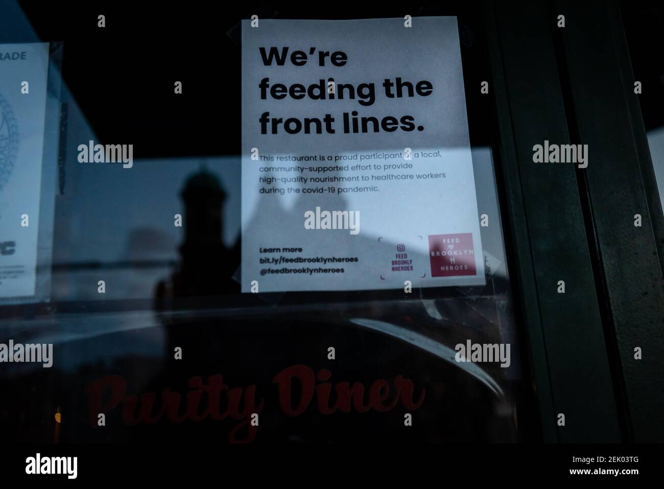 A sign displayed in the window of Purity Dinner tells customers that ...
