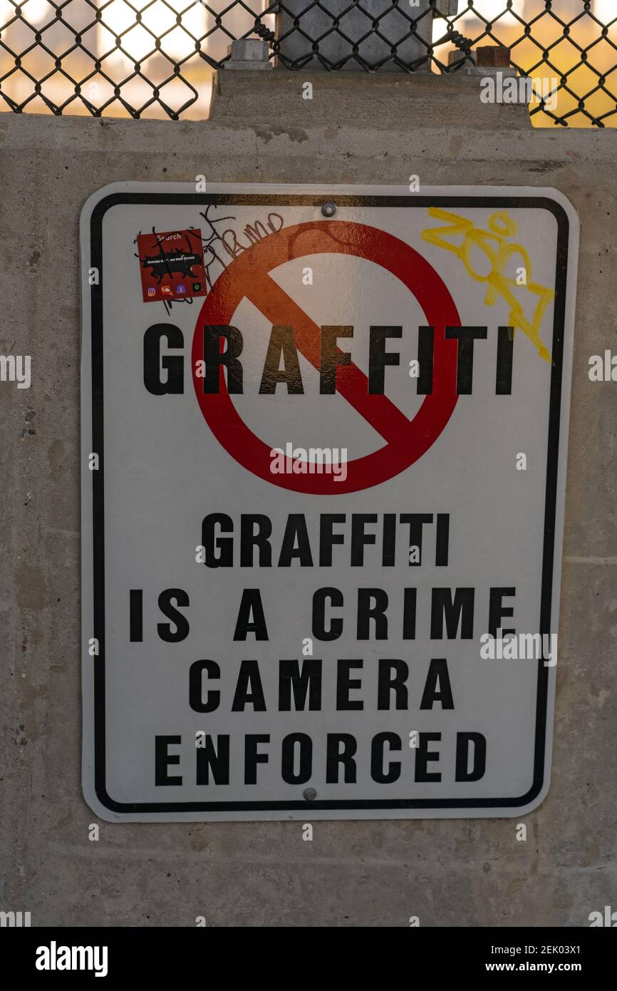 A no graffiti sign is seen at the entrance to a pedestrian walkway on ...