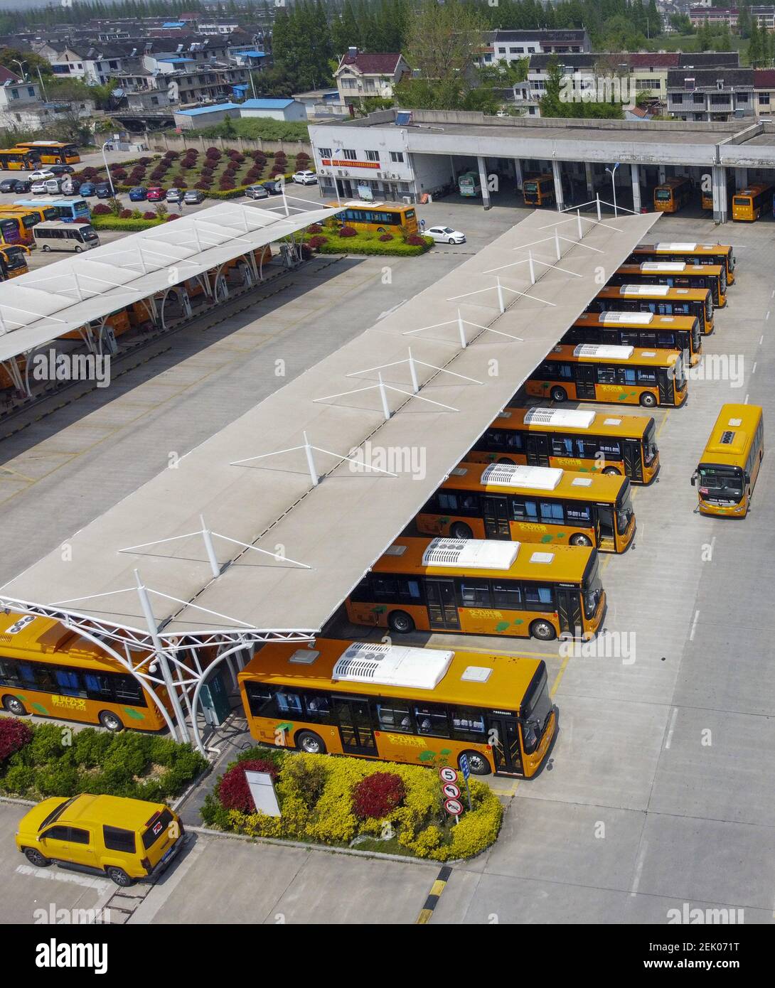 An aerial view of electric buses being charged at a parking lot ...