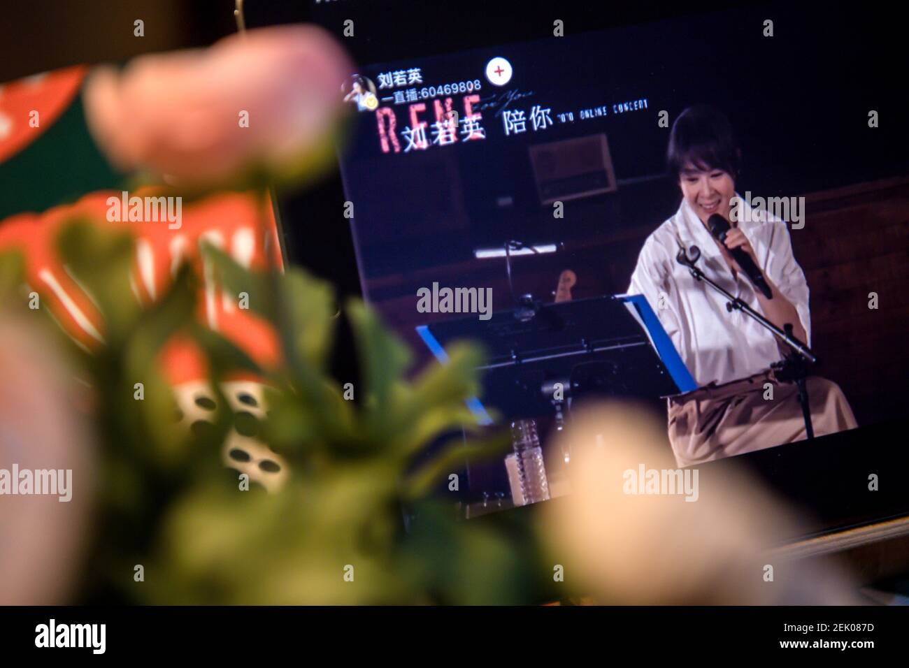 In this unlocated photo, a fan watches a livestream concert of Chinese ...